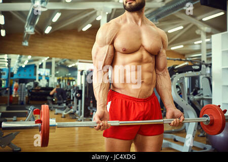 man makes exercises with bar in exercise room Stock Photo - Alamy