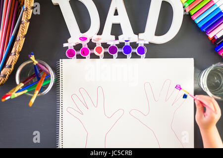 Step by step. Little girl tracing her hands for Father's Day card Stock ...