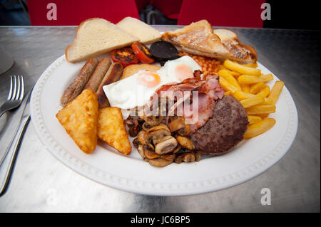 A giant breakfast. Consisting of 2 eggs, 3 bacon, 3 sausage, chips ...