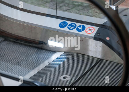Closeup photo of escalator with warning signs Stock Photo - Alamy