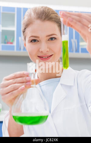 Beautiful blonde woman working at scientist laboratory late at night ...