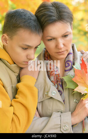 Mother hugging sad son Stock Photo - Alamy