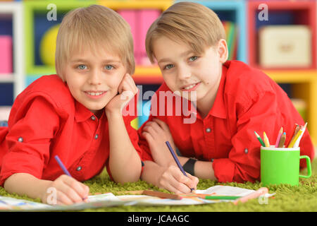 Portrait of two cute brothers draws with pencils Stock Photo - Alamy