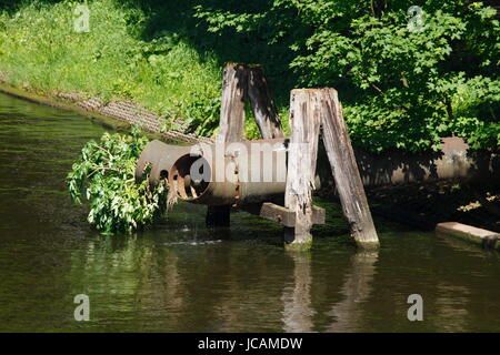 old canal pipes on River Stock Photo - Alamy