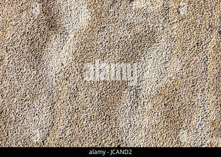 Sand surface after the rain with the visible traces of the raindrops ...