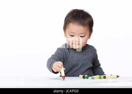 Asian baby boy concentrate on drawing Stock Photo - Alamy
