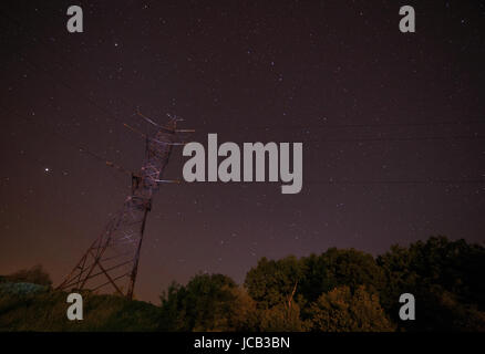 landscape with electricity pylon against starry night sky Stock Photo ...