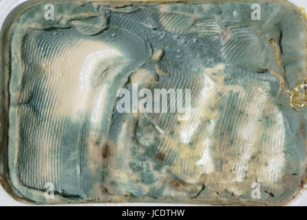 Rotten fresh cheese or butter on tub and black background Stock Photo ...