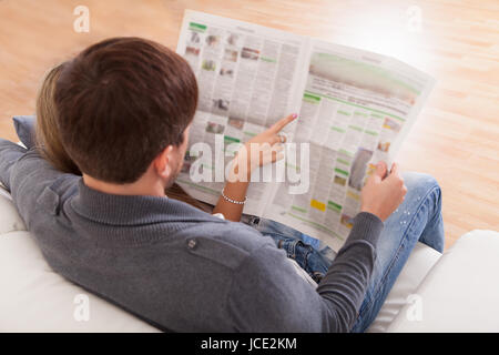 Both read recent article dealing relationships from newspaper Stock ...