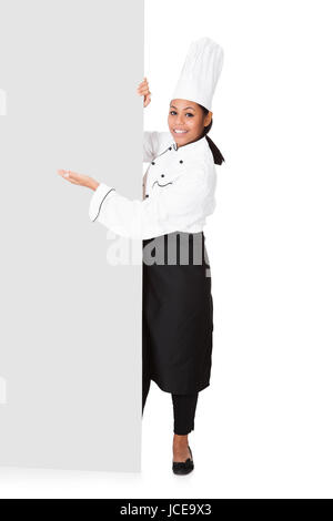Female Cook Standing Behind The Placard. Isolated On White Stock Photo ...