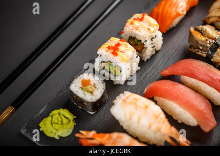 Sushi Set. Different kinds of sushi rolls on wooden serving board Stock ...