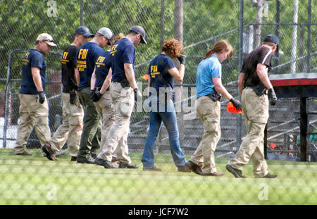 Evidence technicians from the FBI comb through the crime scene for ...
