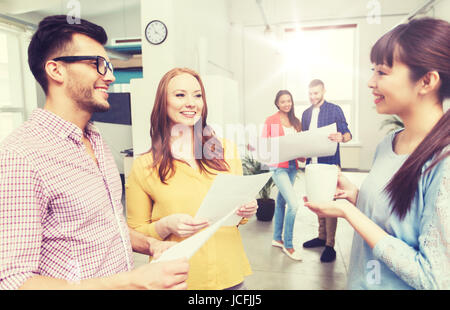 creative team on coffee break talking at office Stock Photo - Alamy