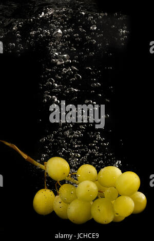 Grapes and splash of juice in air on white background Stock Photo - Alamy