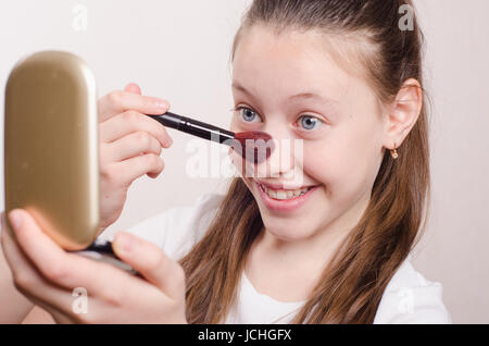 Teen girl having a fun painted cosmetics Stock Photo - Alamy