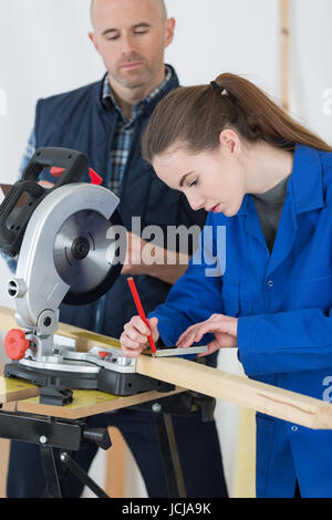 Apprentice learning to use sander Stock Photo - Alamy