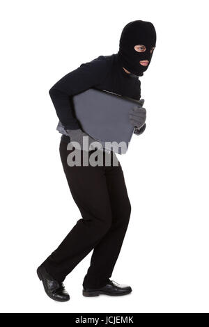 Dangerous burglar dressed in black wearing a mask on head - isolated ...