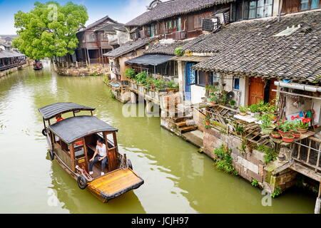 Traditional wooden chinese boat on the Wuzhen canal, Zhejiang province ...