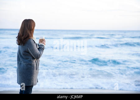 Side view of middle aged female master setting handmade ceramic bowls ...