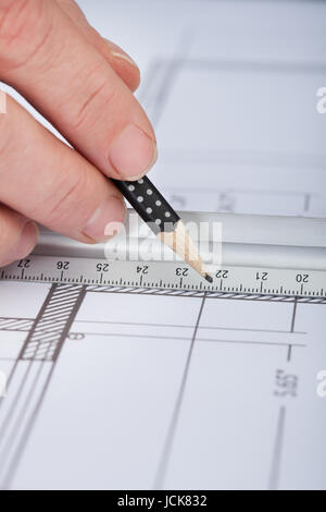 Person's engineer Hand Drawing Plan On Blue Print with architect ...