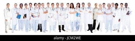 Panoramic shot of doctors looking at nurse while talking in clinic ...