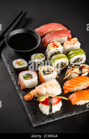 Set of different sushi nigiri, soy sauce and chopsticks over white ...