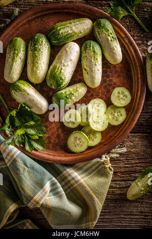 Top view of fresh sliced cucumbers on green background with copy space ...