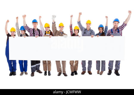 Diverse group of workmen and woman in their overalls and hardhats ...