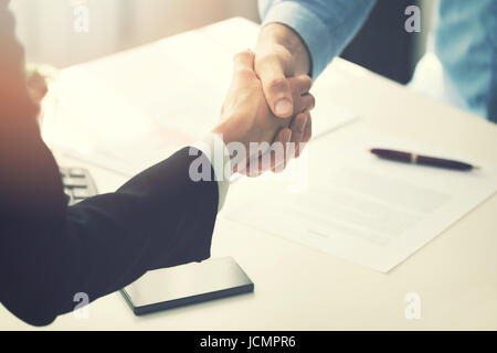 handshake of business people after the signing of the contract ...