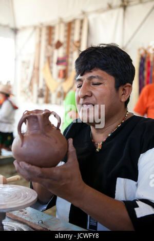 An indigenous Colombian pottery artist holding a pot Stock Photo - Alamy