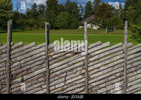 Old farm house and traditional roundpole fence in a rural landscape at ...