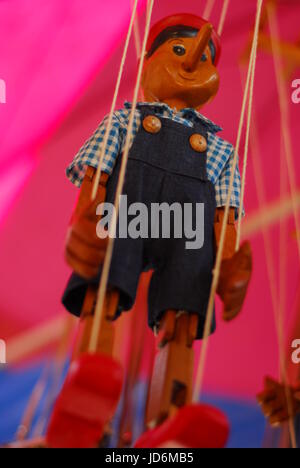 Vintage wooden Pinocchio string puppet in the window of an antique shop ...