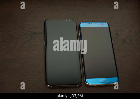 Smartphones laying on a table Stock Photo - Alamy
