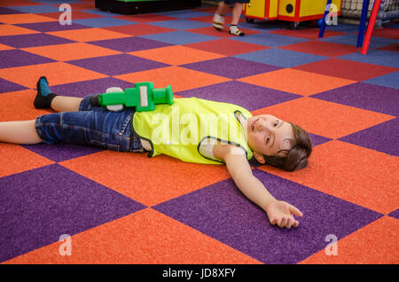 Young boy playing dead on the floor Stock Photo - Alamy