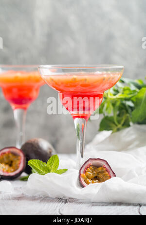 Fresh passion fruit maracuja alcoholic cocktail with ice cubes on ...