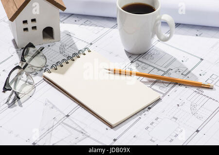 Construction projects. Planning. Open blueprints with a pencil and ...