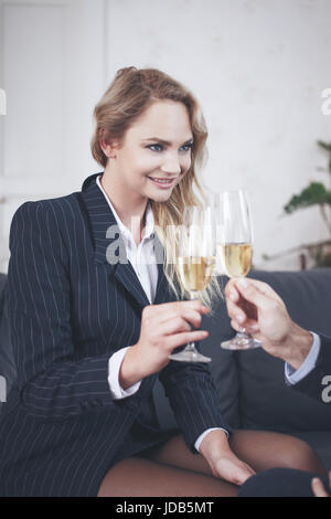 Business woman with a glass of champagne congratulates Merry Christmas ...