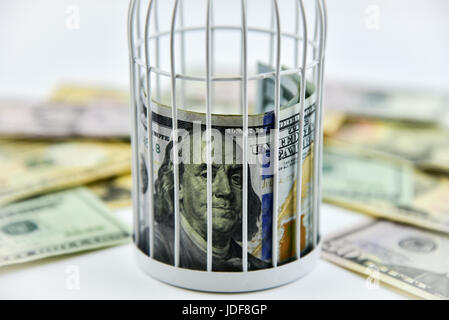 Banknotes trapped inside the cage, behind bars Stock Photo - Alamy