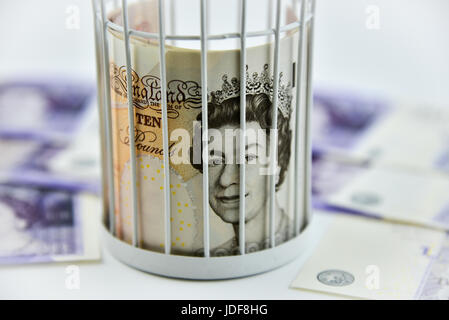 Banknotes trapped inside the cage, behind bars Stock Photo - Alamy