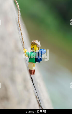 Miniature mountain climbing figures, climbing between wooden blocks ...