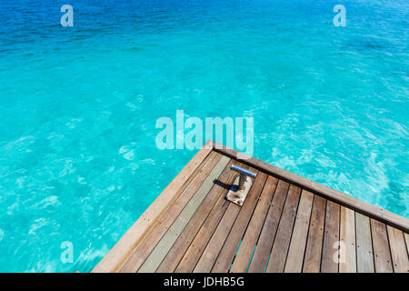 Wooden pier with blue sea and sky background Stock Photo - Alamy