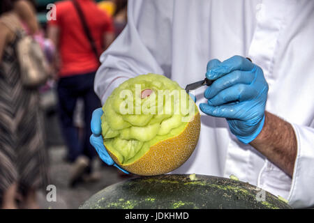 Zemun, Serbia - Man carving melon on the green market stand Stock Photo ...