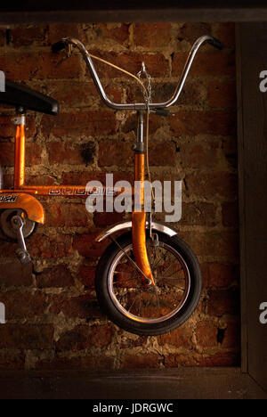 Orange Raleigh Chopper bicycle from above parked on stone flagged ...