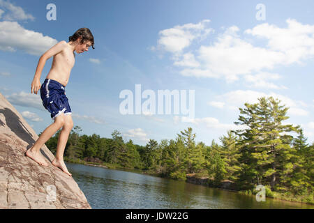 boy climbing rock barefoot Stock Photo: 153555760 - Alamy