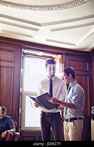 Businessmen talking in ornate room Stock Photo - Alamy