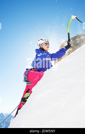 Female mountain climber using ice pick Stock Photo - Alamy