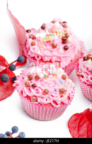 pink colored fresh muffins with different candies Stock Photo - Alamy