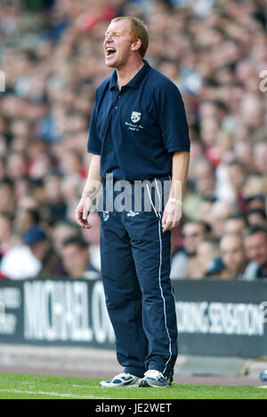 West Bromwich Albion football manager Bobby Gould apprehends a fan who ...