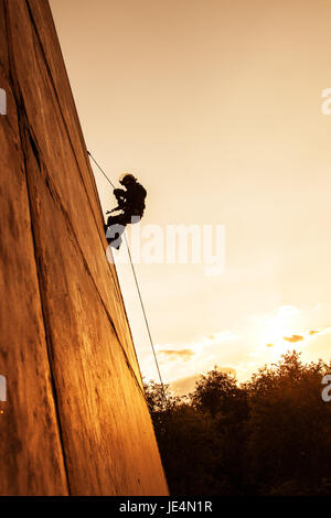 Silhouette of police officer during rope exercises with weapons Stock ...