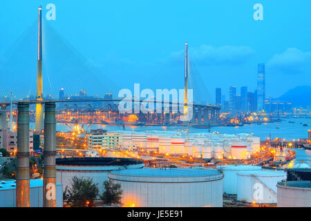 gas tank and highway bridge in sunset moment Stock Photo - Alamy